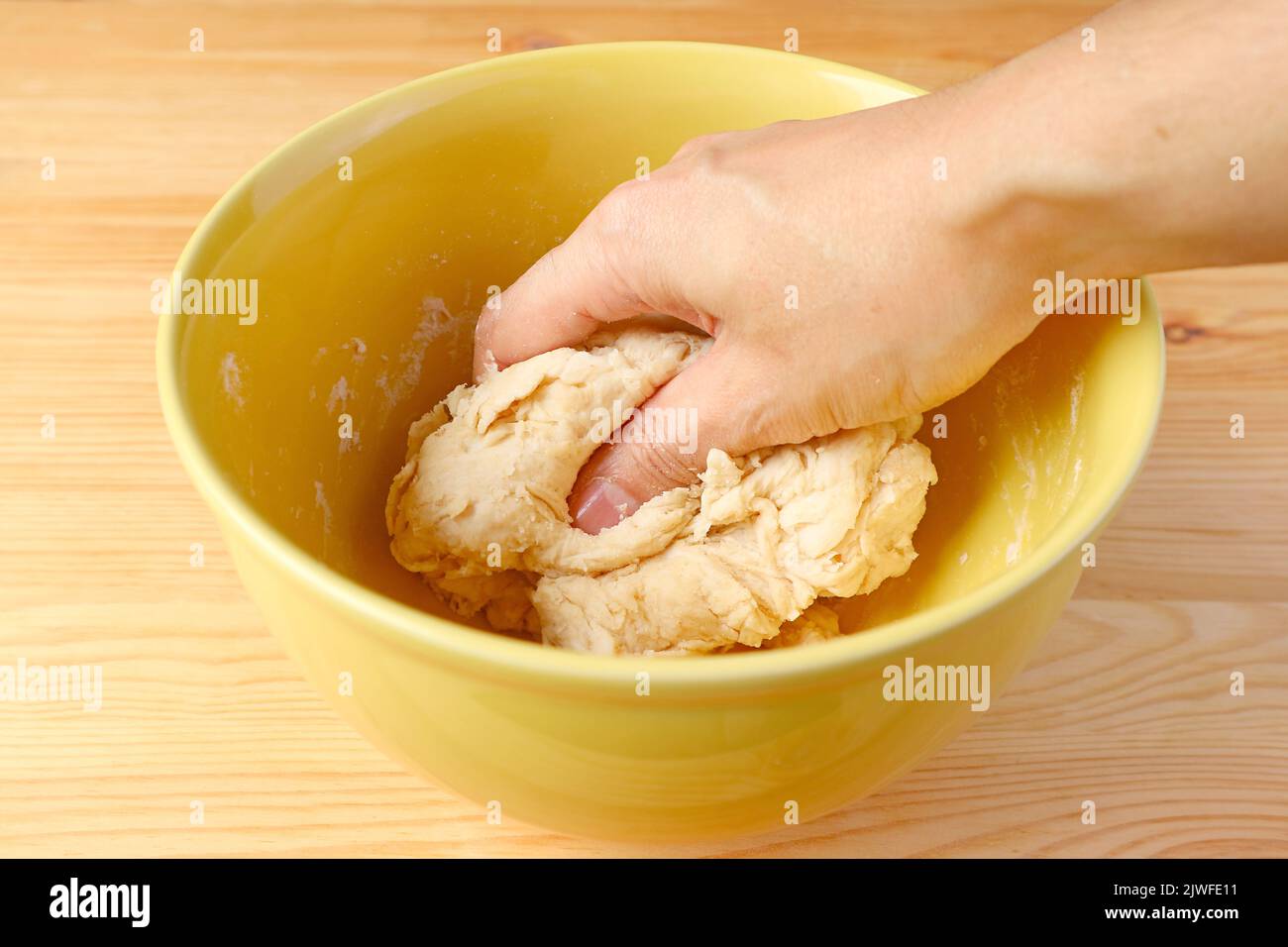 Hand Kneading Bread Dough In A Mixing Bowl Stock Photo Alamy