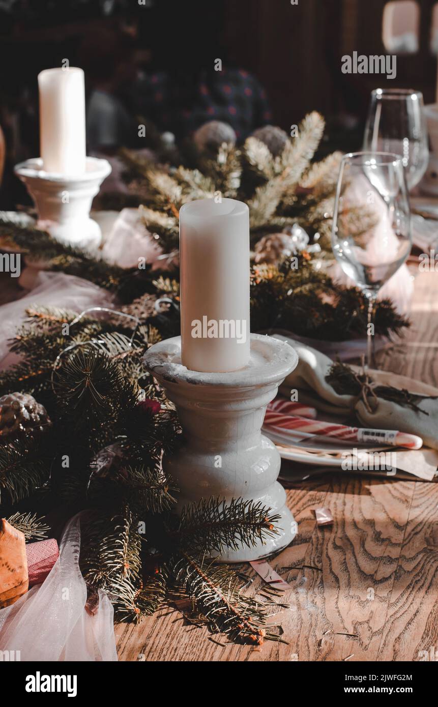 Christmas table decoration. Candle on a decorated Christmas table Stock ...