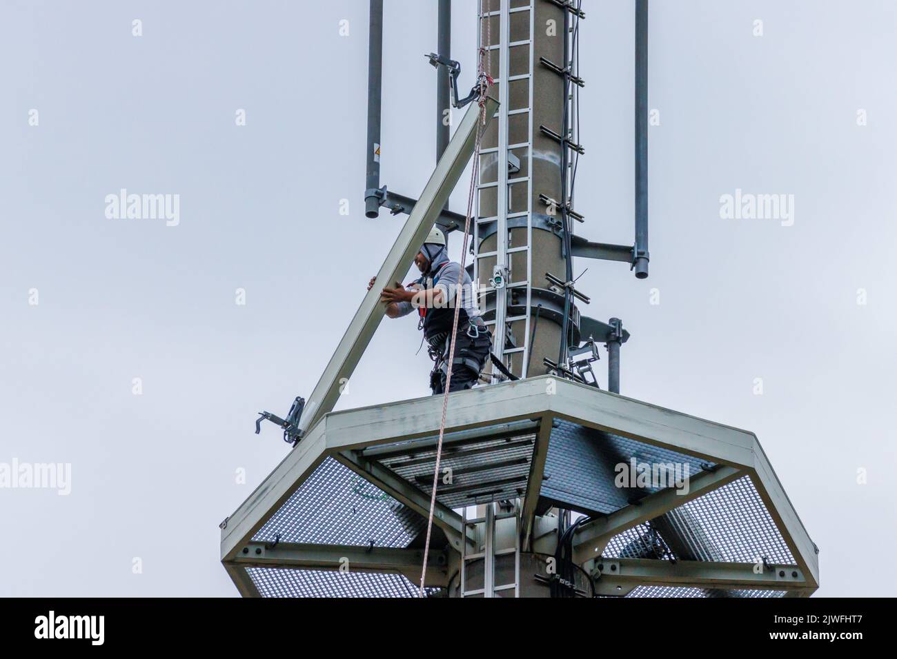two technicians carry out repairs on a radio mast Stock Photo - Alamy