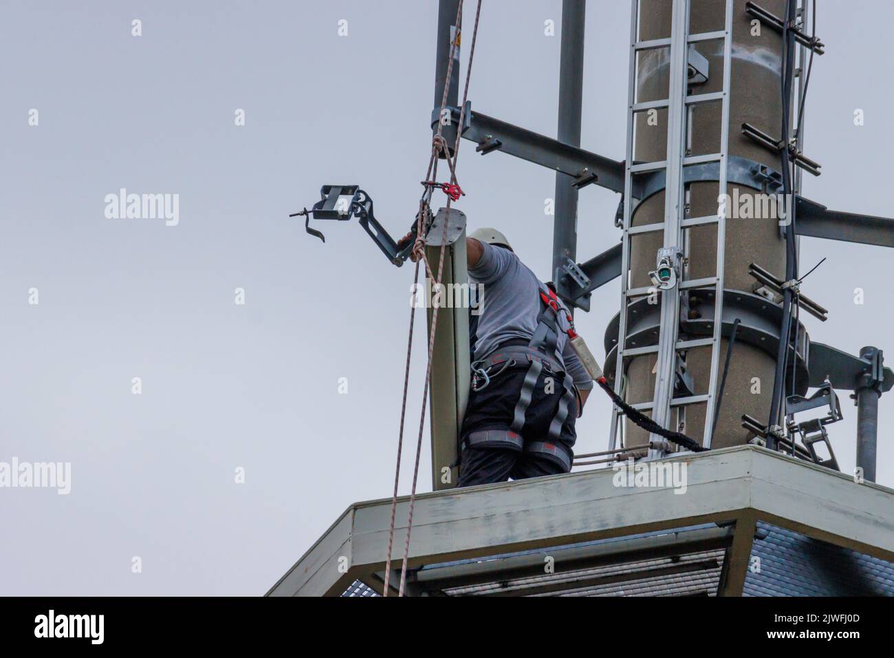 two technicians carry out repairs on a radio mast Stock Photo - Alamy