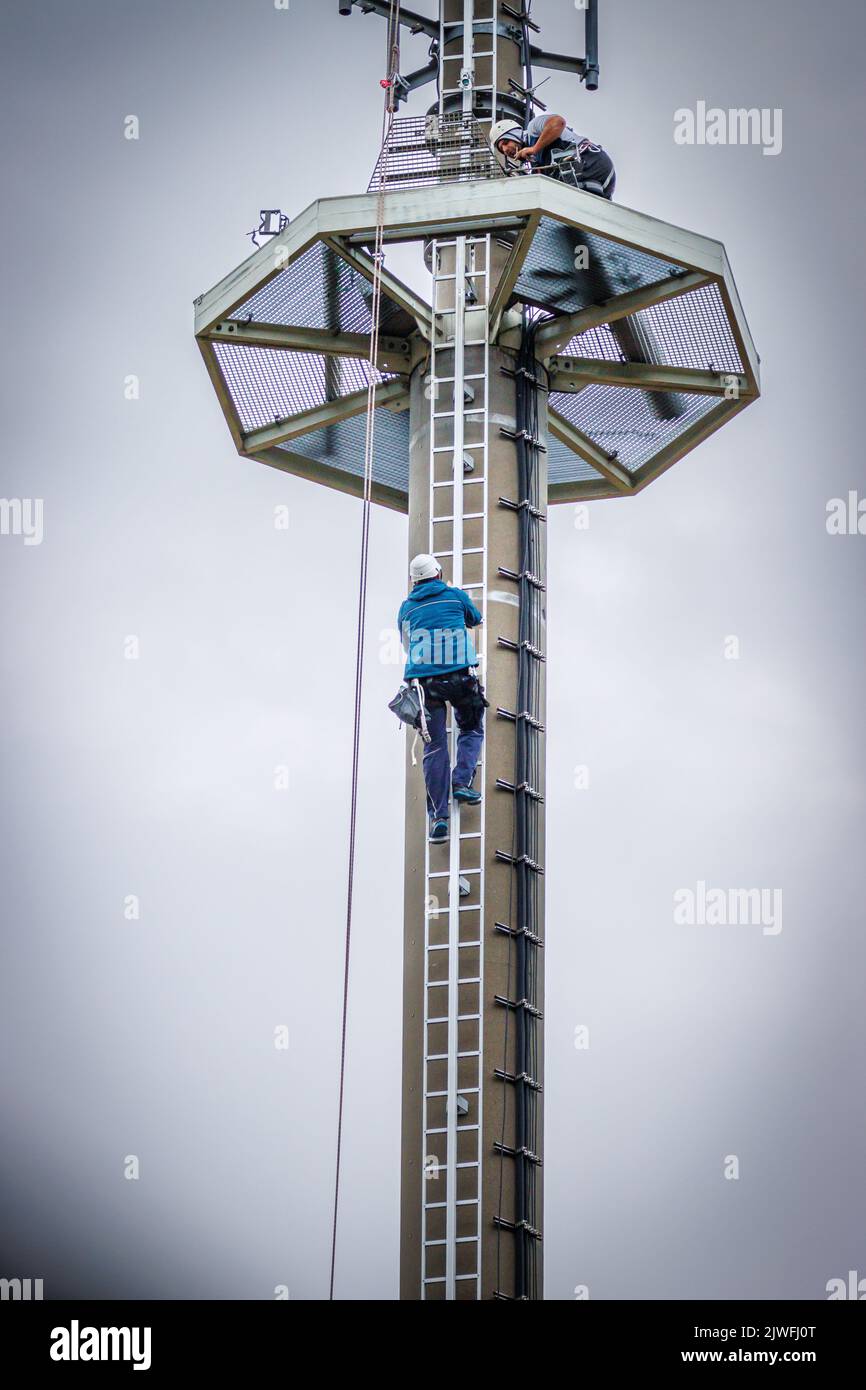 two technicians carry out repairs on a radio mast Stock Photo - Alamy