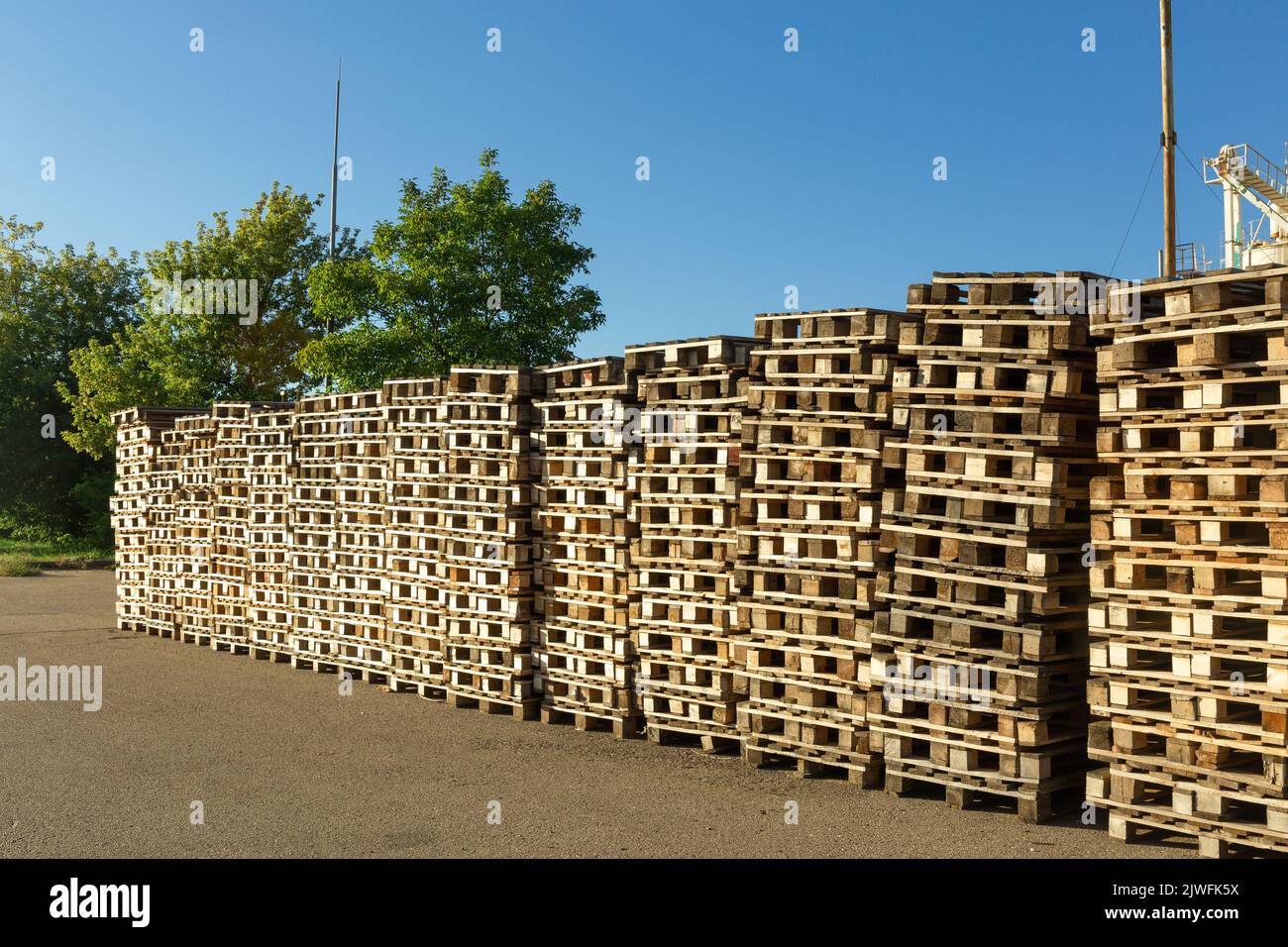 Stacks of wooden pallets in a warehouse yard of factory. Pallets for ...
