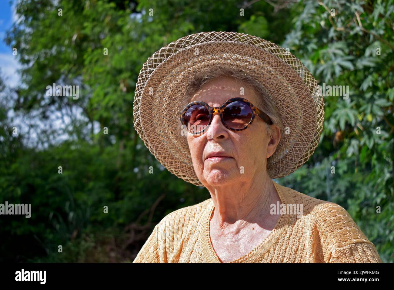 Senior old woman sunbathing in the park Stock Photo - Alamy