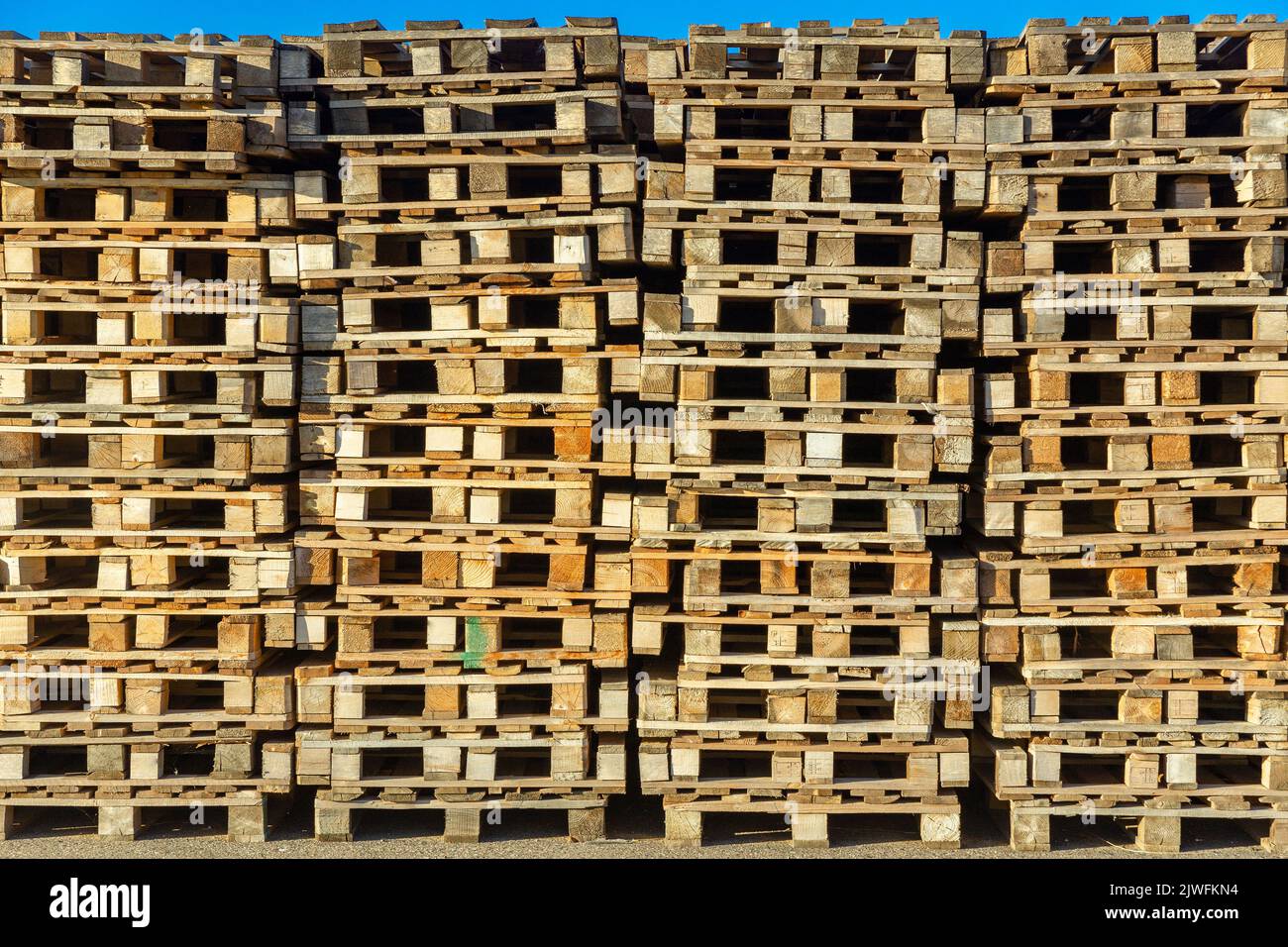 Stacks of wooden pallets in a warehouse yard of factory. Pallets for ...
