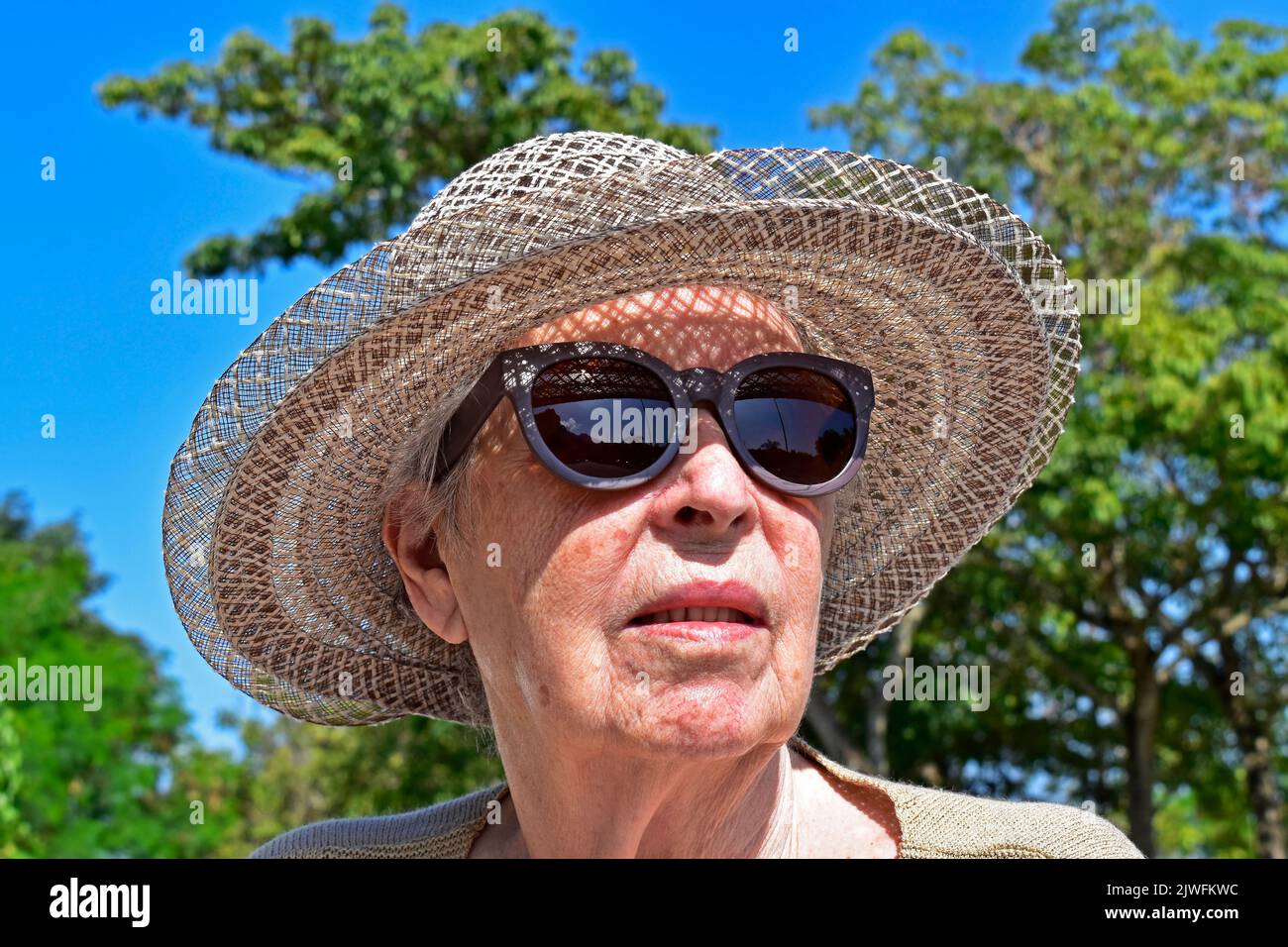 Senior old woman sunbathing in the park Stock Photo - Alamy