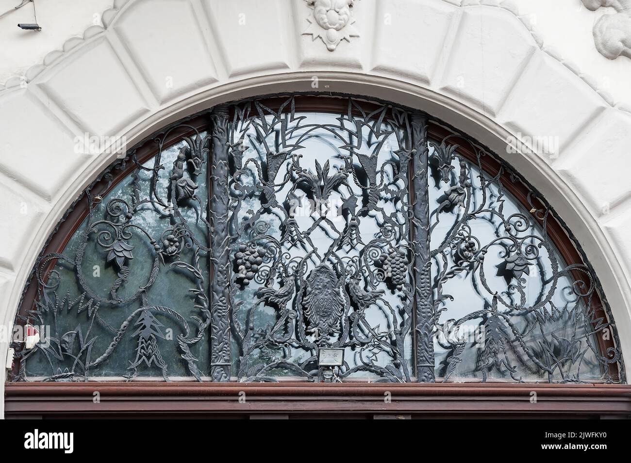 Beautiful window of the old Art Nouveau house with ornate grapes ...