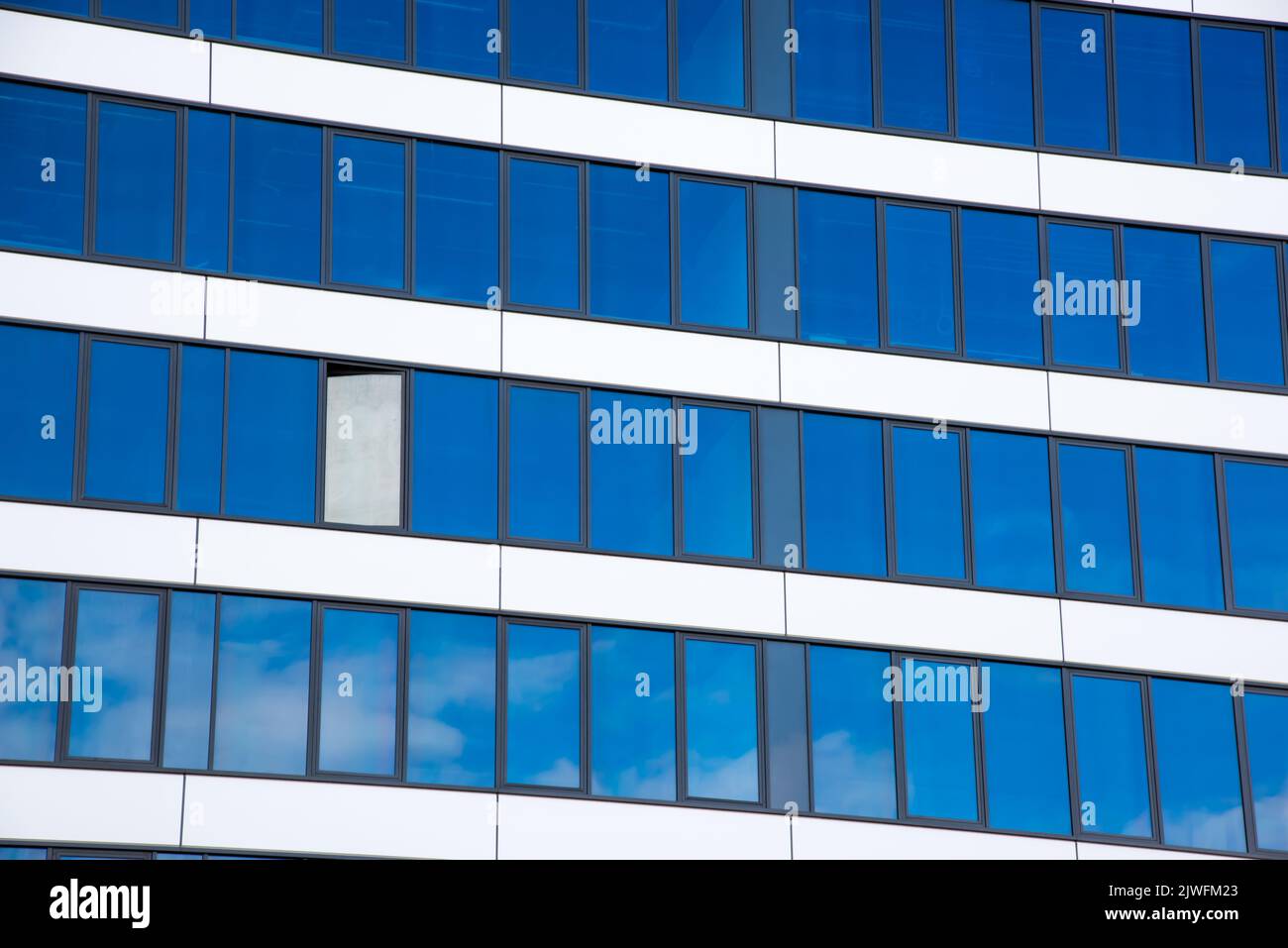 A glass facade with an open window Stock Photo - Alamy