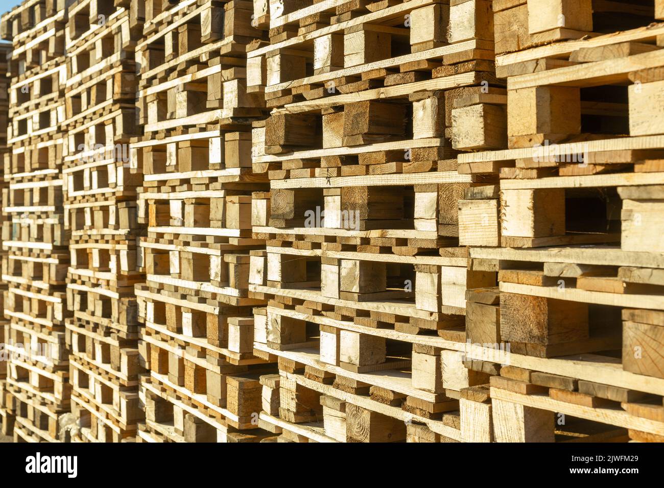Stacks of wooden pallets in a warehouse yard of factory. Pallets for ...