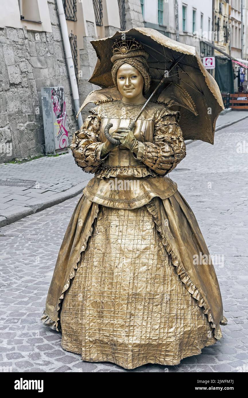 Unidentified busking mime in the retro costume with umbrella on street ...