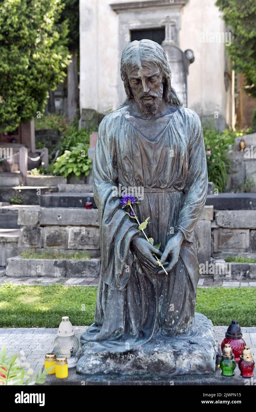 Christ on bended knees sculpture tombstone at the ancient Lychakiv ...