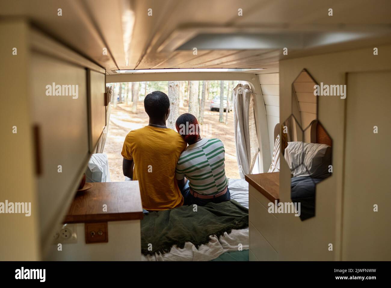 Rear view of African young couple enjoying nature together while ...
