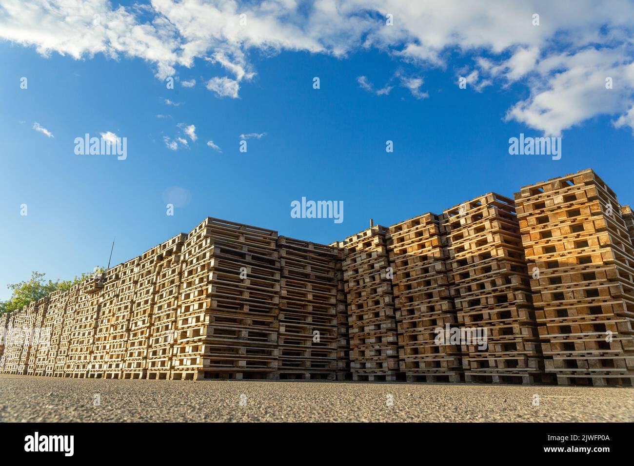 Stacks of wooden pallets in a warehouse yard of factory. Pallets for ...