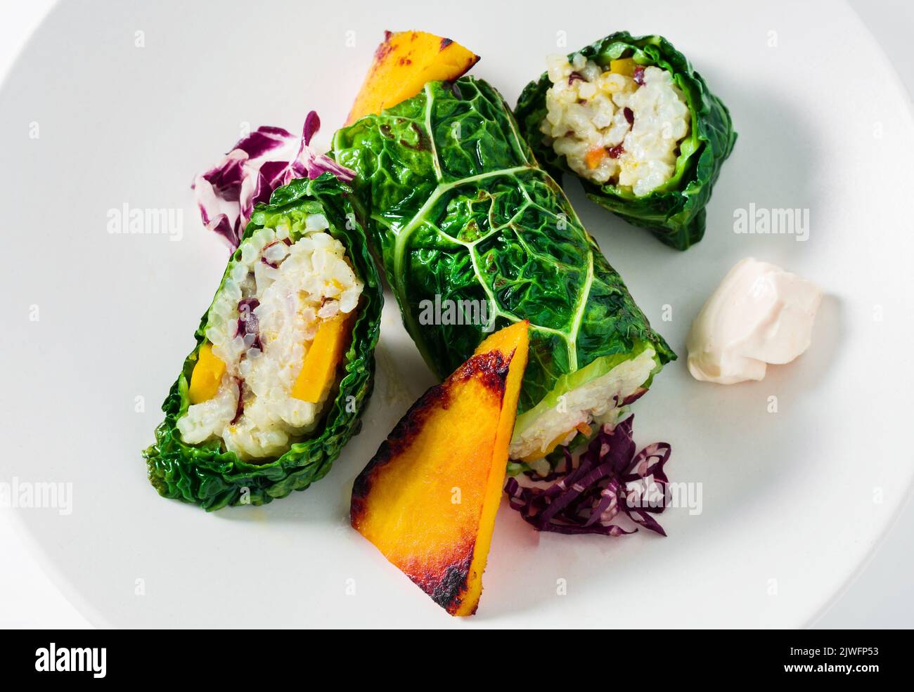 vegan restaurant dish: savoy cabbage rolls with rice and baked ...