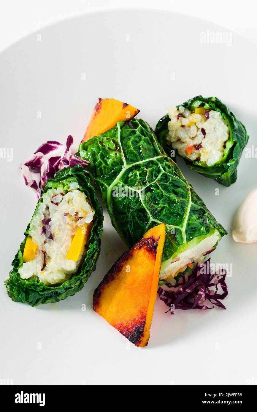 vegan restaurant dish: savoy cabbage rolls with rice and baked ...