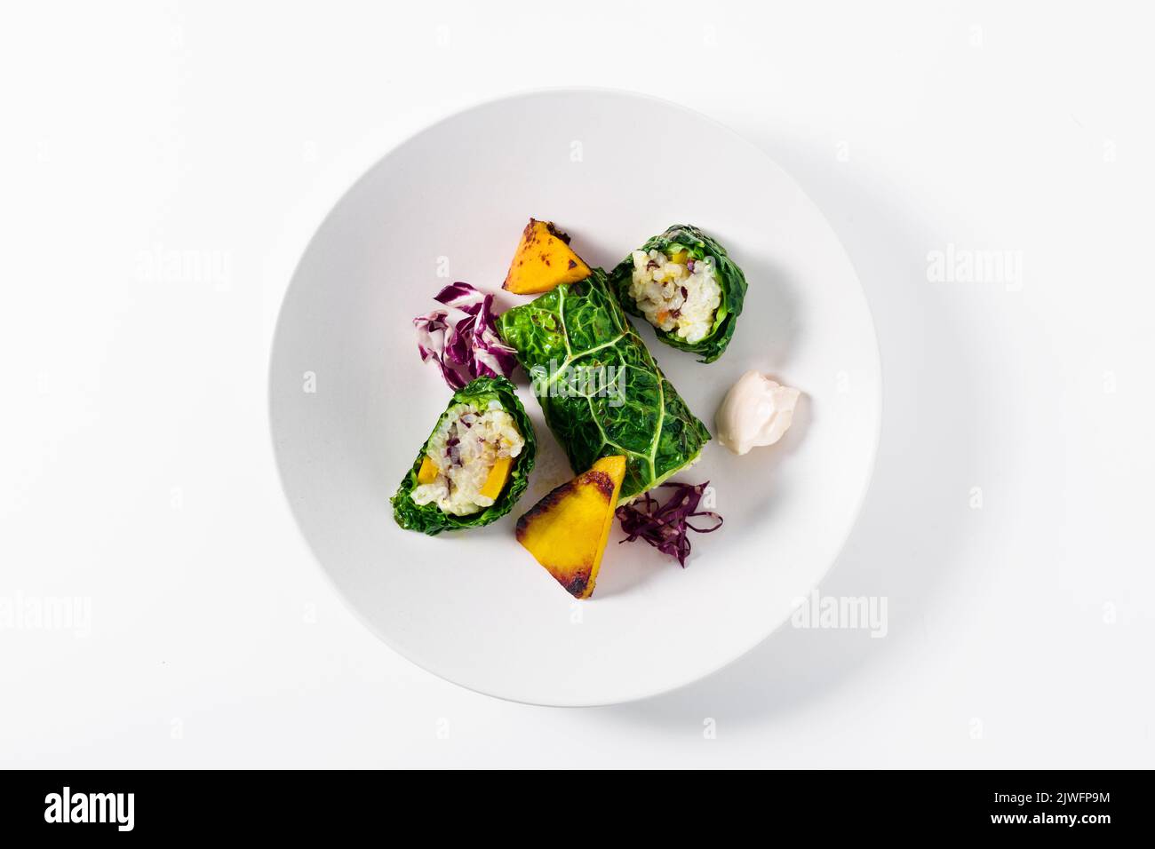 vegan restaurant dish: savoy cabbage rolls with rice and baked ...