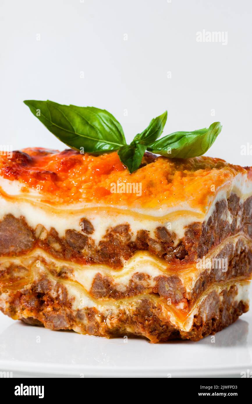 real italian lasagna with meat and parmesan cheese on white. fresh ...