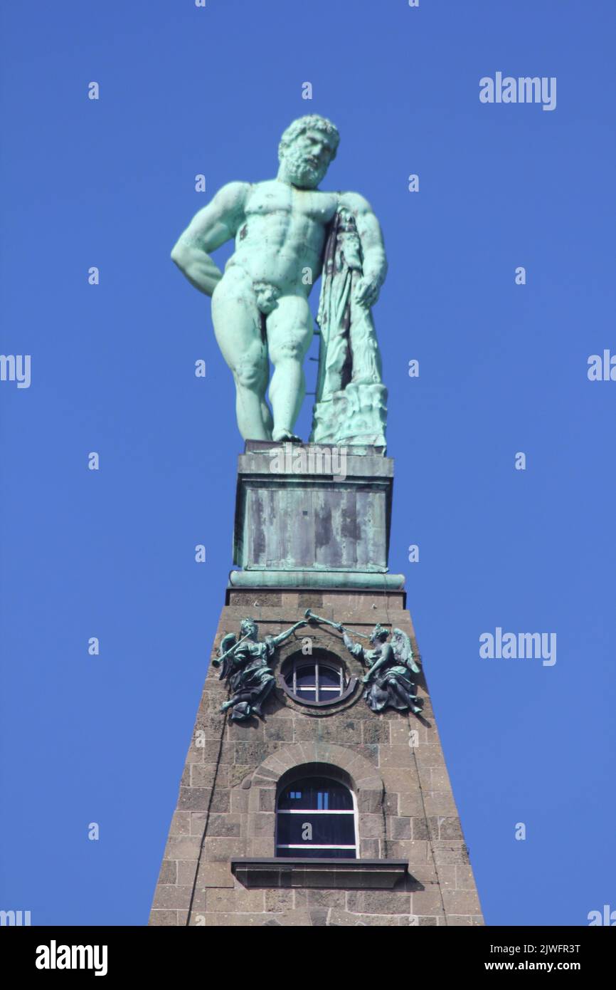 a Hercules statue with blue sky in the background Stock Photo - Alamy