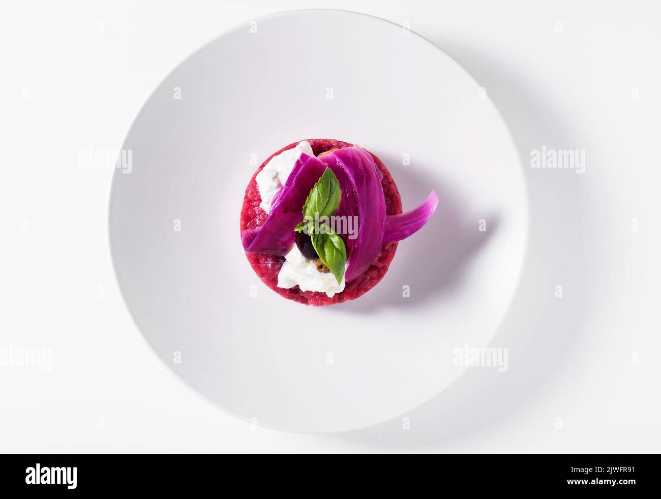 Beef tartare with fresh cheese, pickled onion, olives and fresh basil ...