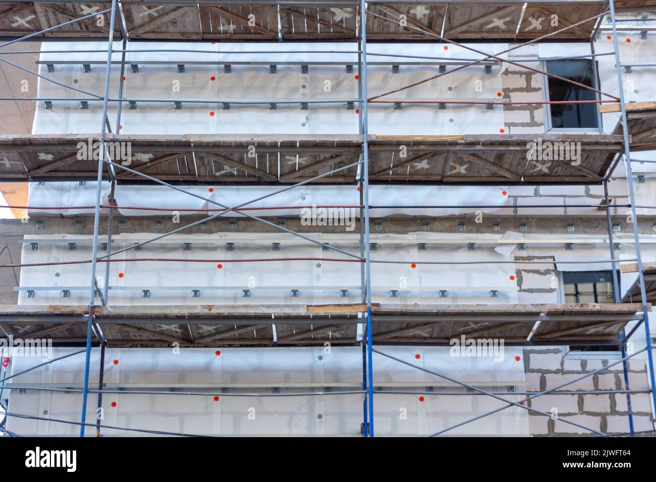 Insulation of the exterior walls of a building under construction. The ...