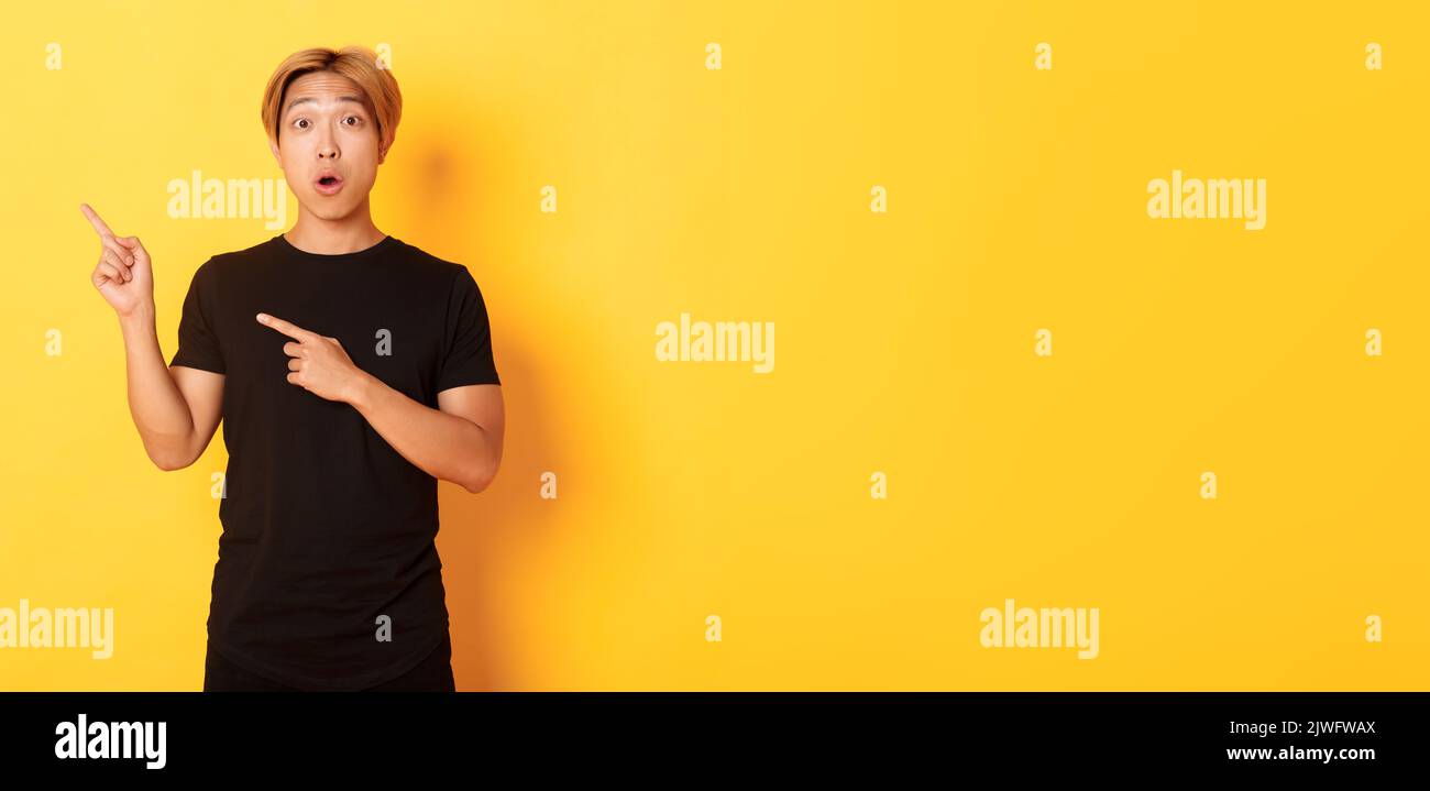 Portrait Of Impressed And Excited Handsome Asian Guy In Black T Shirt