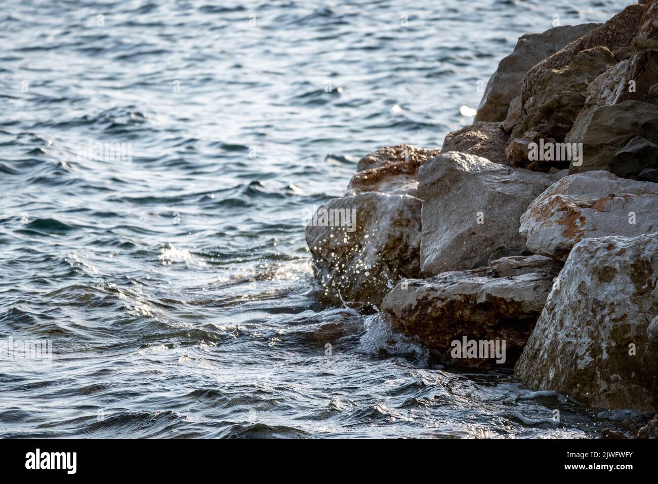 Stone rocks submerged in the shallows of Mimice beach, Croatia Stock ...