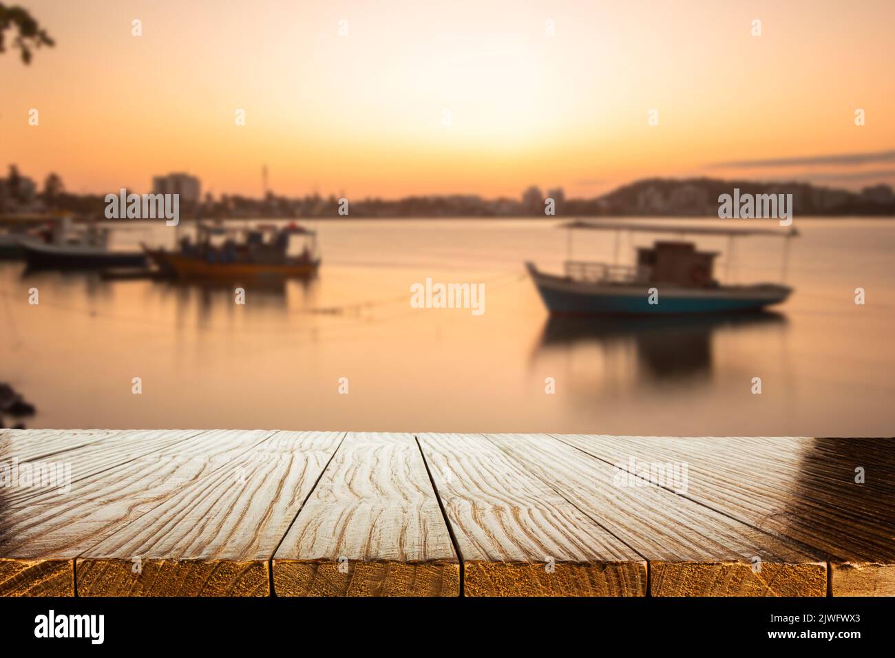 Empty wood table with blurred background with sunset landscape and ...