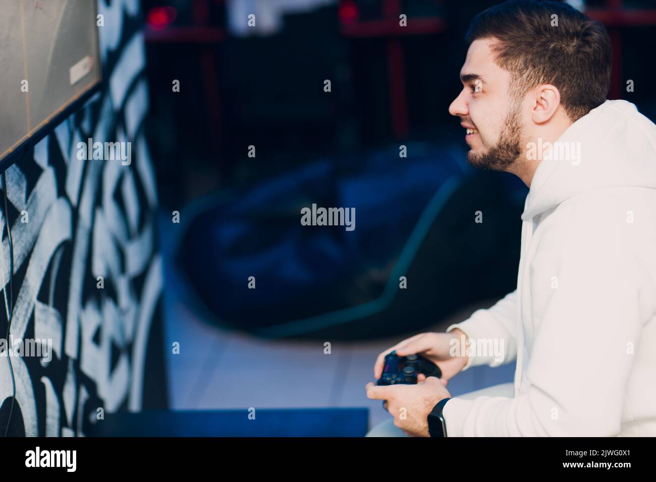 Guy young adult man gamer playing video game on game console at ...