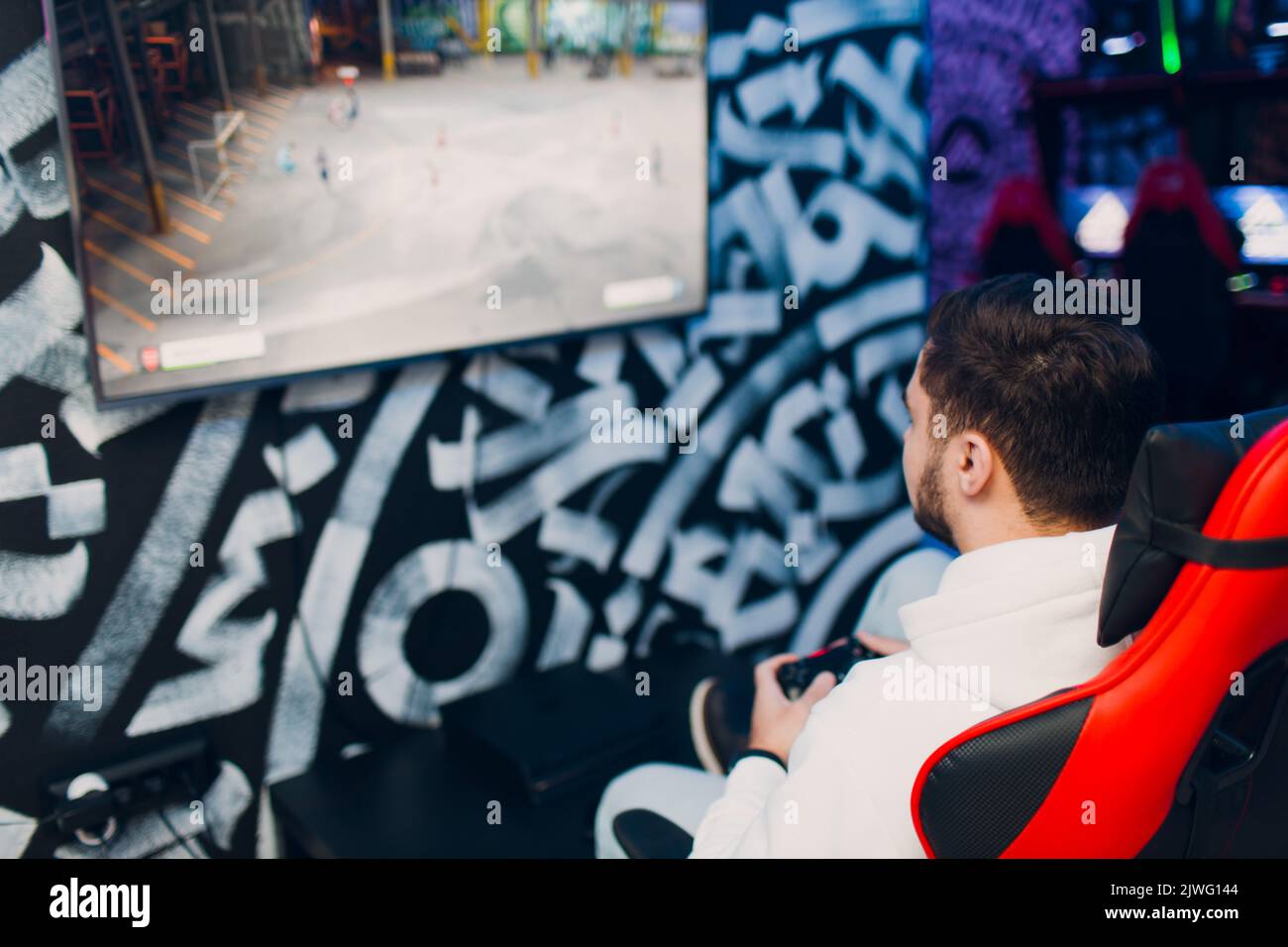 Guy young adult man gamer playing video game on game console at ...