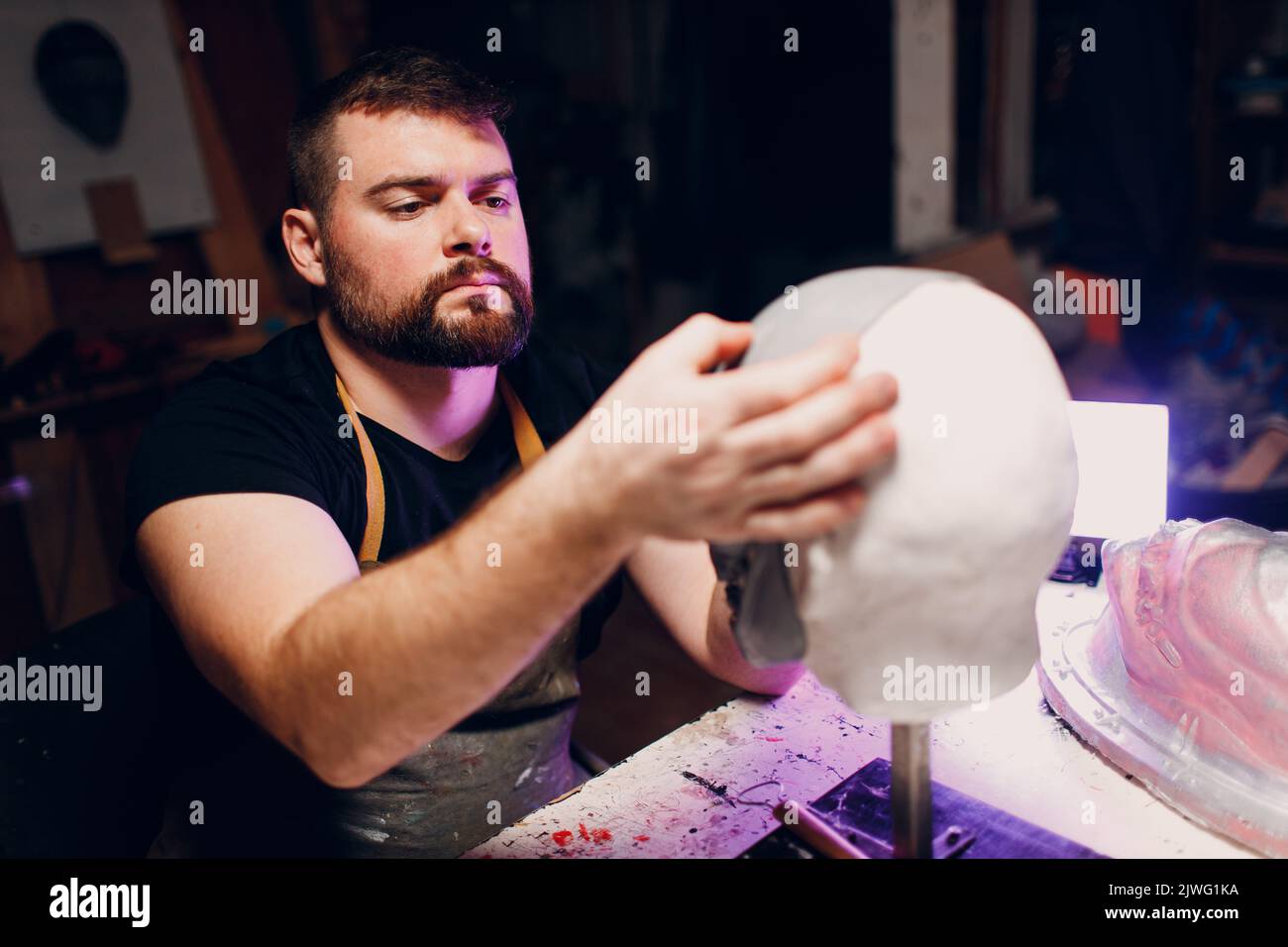 Artisan craftsman create mask based on plaster cast. Gypsum mold and ...
