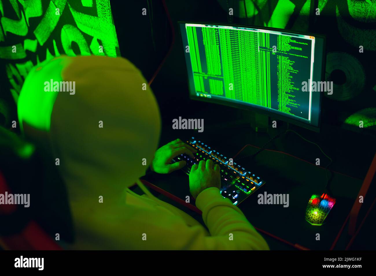 Hacker in hoodie working hacks code site on personal computer. War and ...