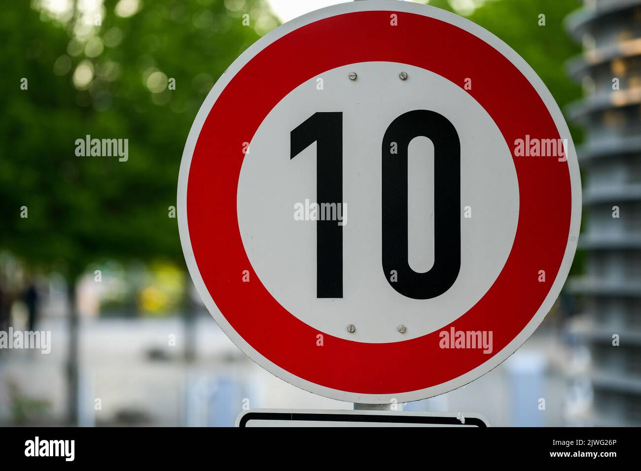 A round red traffic sign showing 10 speed limit Stock Photo - Alamy