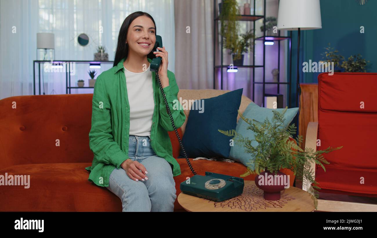Portrait of caucasian girl making wired telephone conversation with ...