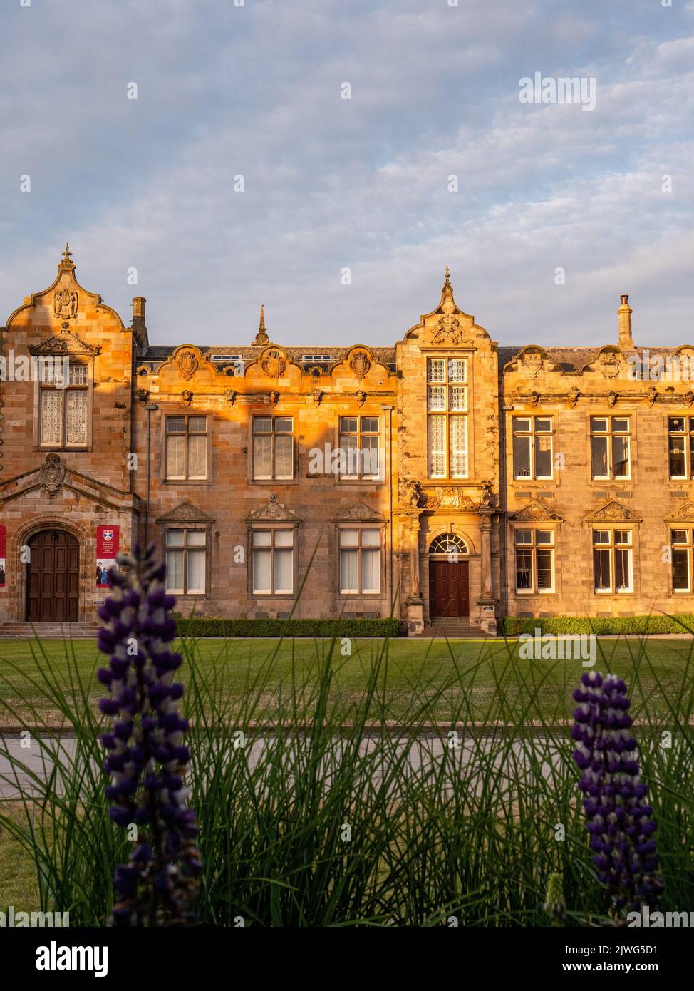 The exterior design of University of St. Andrews against cloudy sky in ...