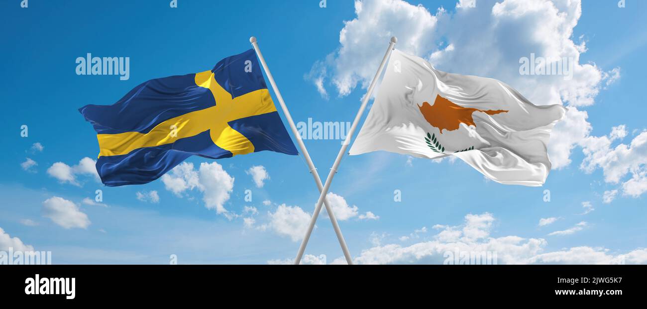 two crossed flags Cyprus and Sweden waving in wind at cloudy sky ...