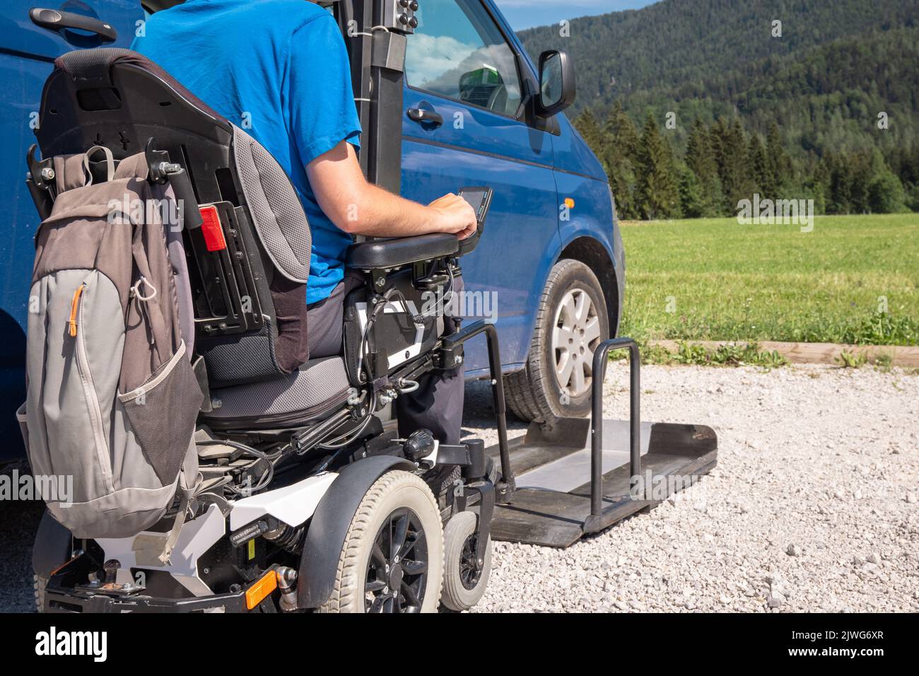 Man with disability a frequent traveller, getting off a van using the ...