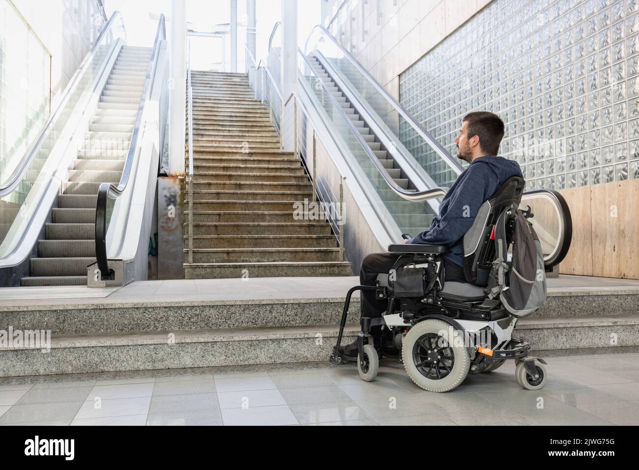 Person with disability on electric wheelchair stopping at the bottom of ...