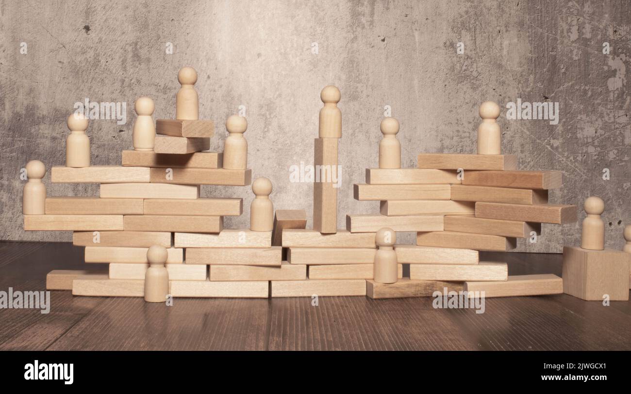 The word barrier on tiered wooden cubes with a walking stick man on ...