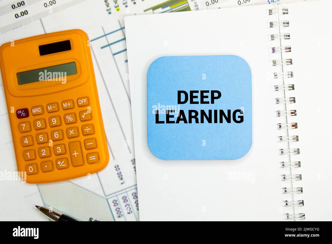 DEEP LEARNING text on a paper with keyboard, calculator on grey ...
