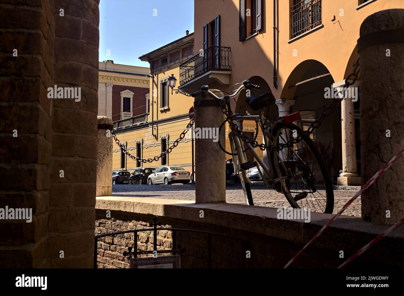 Bike chained on a pole in a street Stock Photo - Alamy
