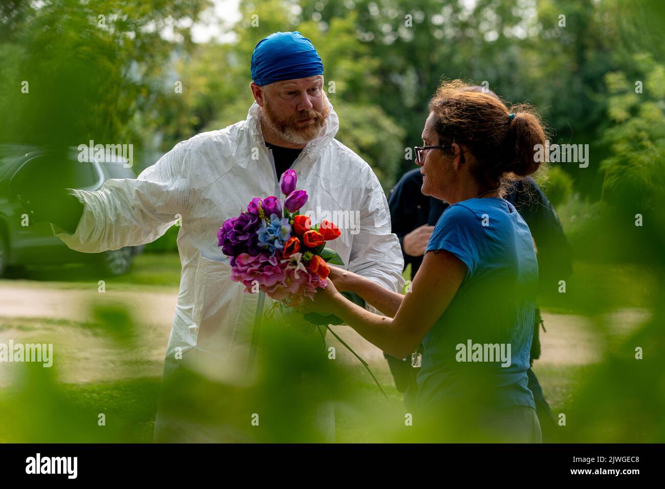 Ruby Works speaks with a forensic investigator before bringing flowers ...