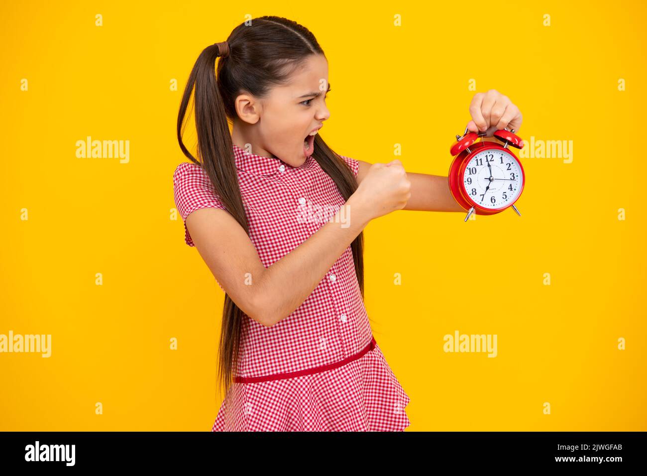 Child 12, 13, 14 years old look at alarm clock. Time for shopping sales ...