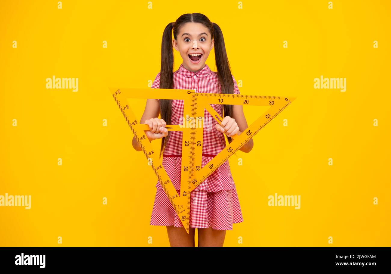 Amazed teenager. Teenager child school girl holding measure for ...