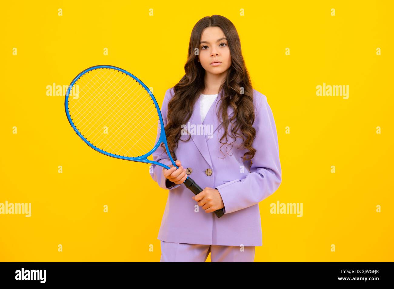 Fashion teenage tennis player girl in trendy suit hold tennis racket ...