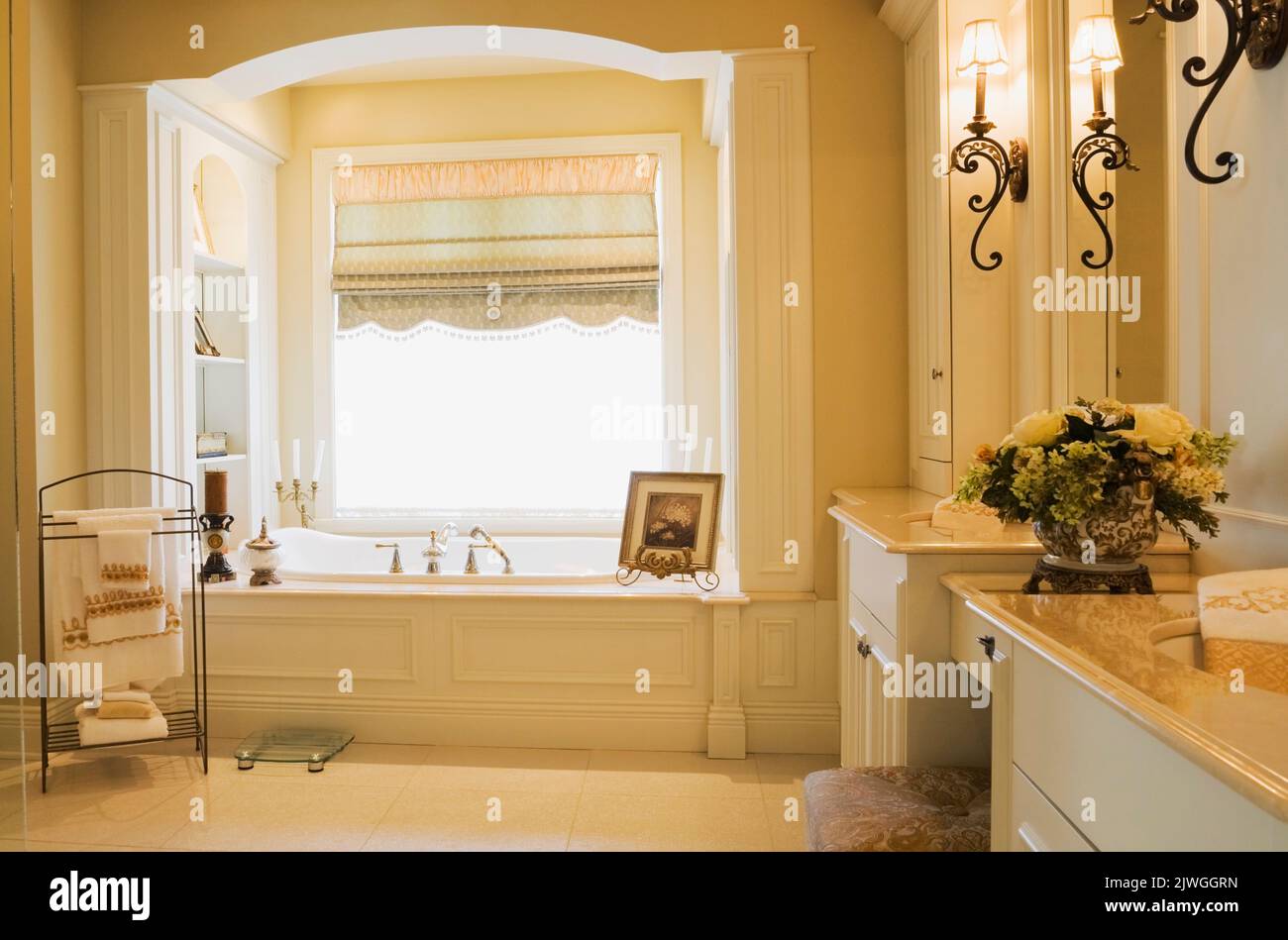 Modern bathroom with bathtub encased in wooden panels and white wooden ...