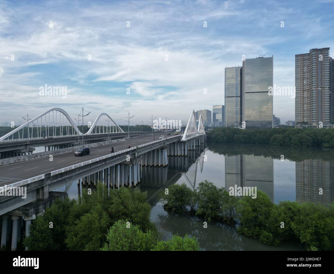 A beautiful modern bridge in Pantai Indah Kapuk, Jakarta, on a cloudy ...
