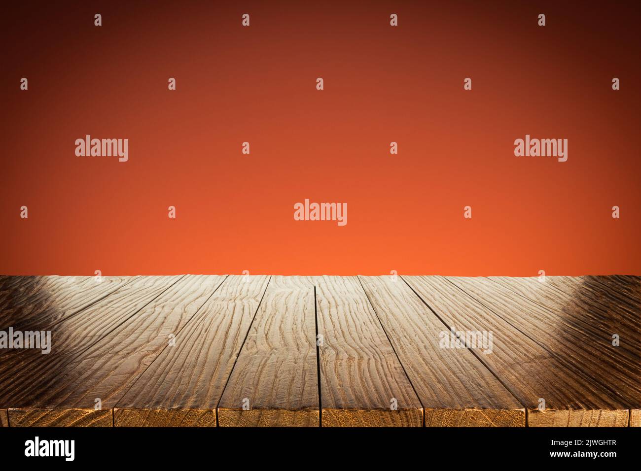 Empty wood table with orange background and vignette. Product display ...