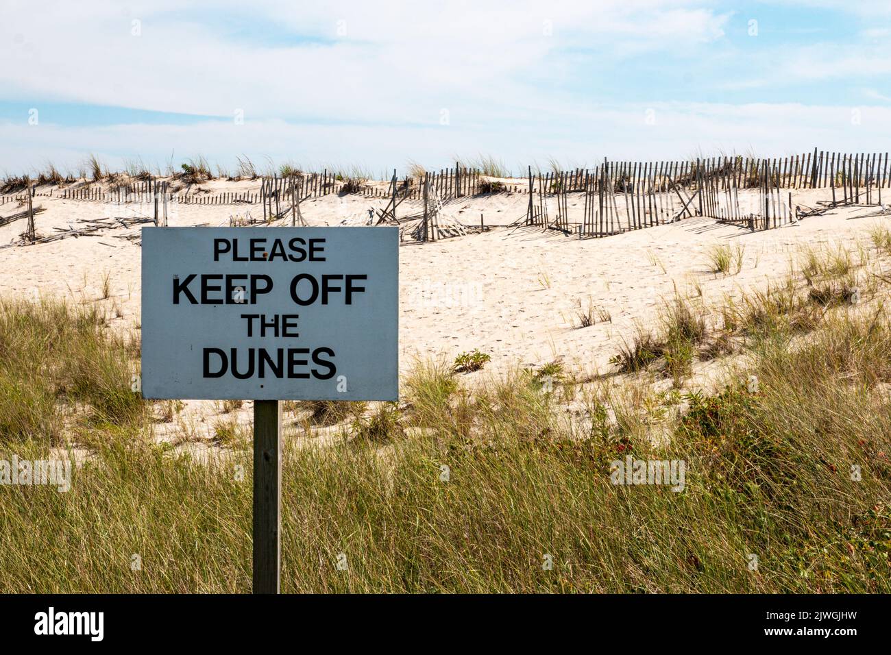 Please keep off the dunes sign with broken snow fences in the backgound ...
