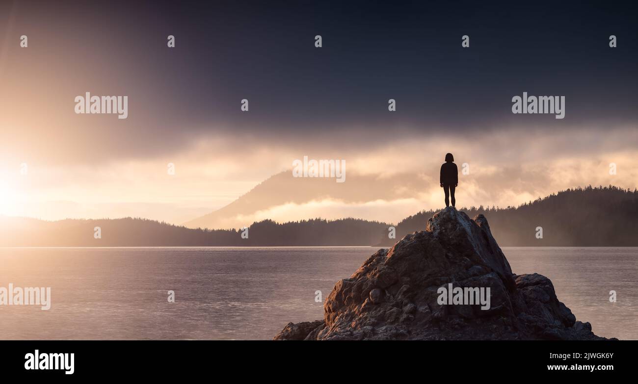 Adventurous Woman Hiking on the Rocky Coast with Mountains and Dramatic ...