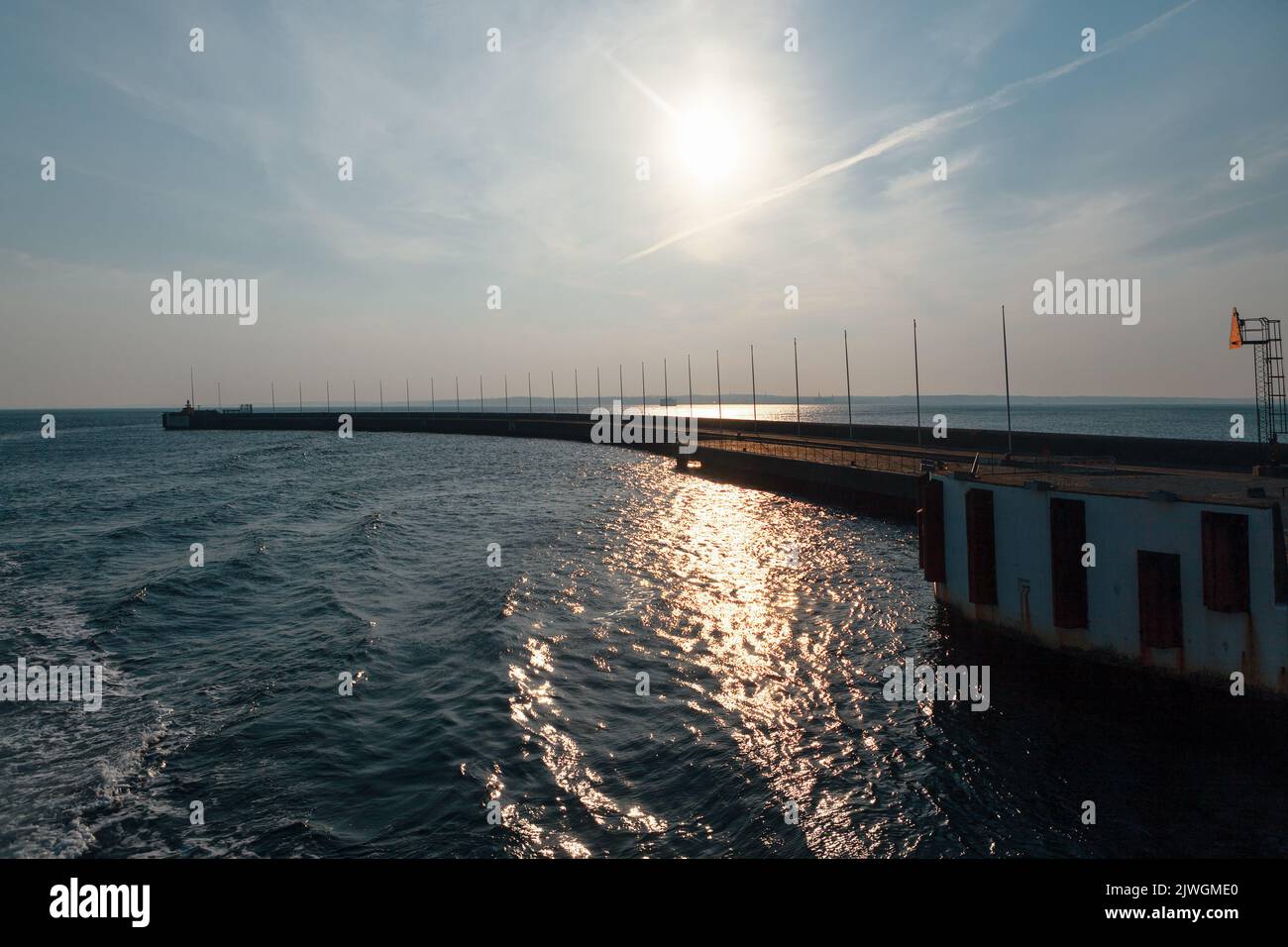 Berth into blue sea . Long marine harbor . Sunrise over the sea Stock ...