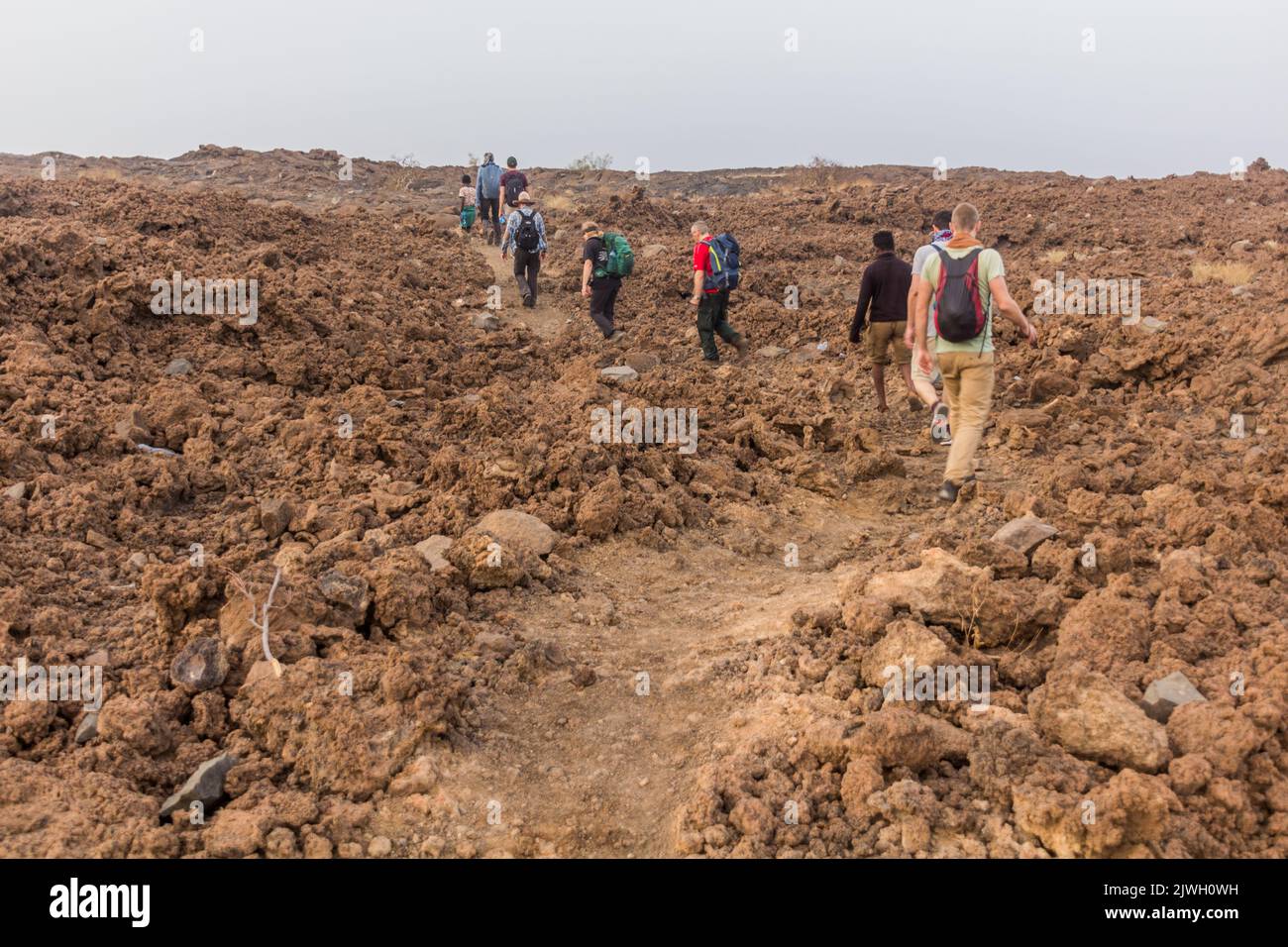 AFAR, ETHIOPIA - MARCH 26, 2019: Tourists walking across lava fields at ...